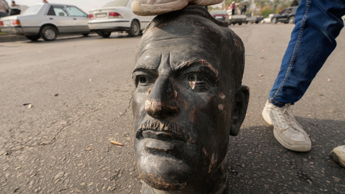 Syrian rebels topple statues as Assad regime collapses | IN PICS