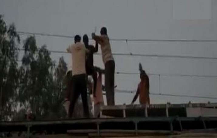 Video shows dramatic rescue of man dangling from overhead wire on ...